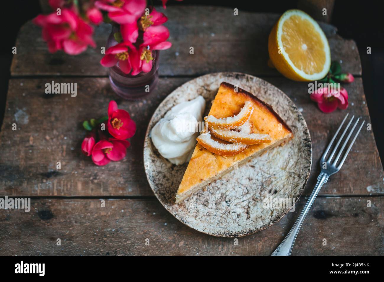 Slice of lemon ricotta cake on a dessert plate on rustic vintage chair ...
