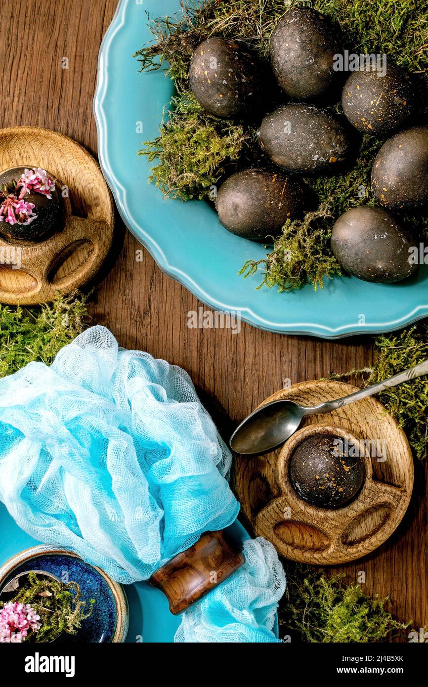 Easter table setting with empty turquoise ceramic plates and egg cups ...