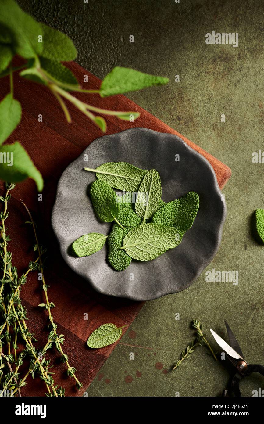 Sage and Thyme herbs on a plate Stock Photo - Alamy
