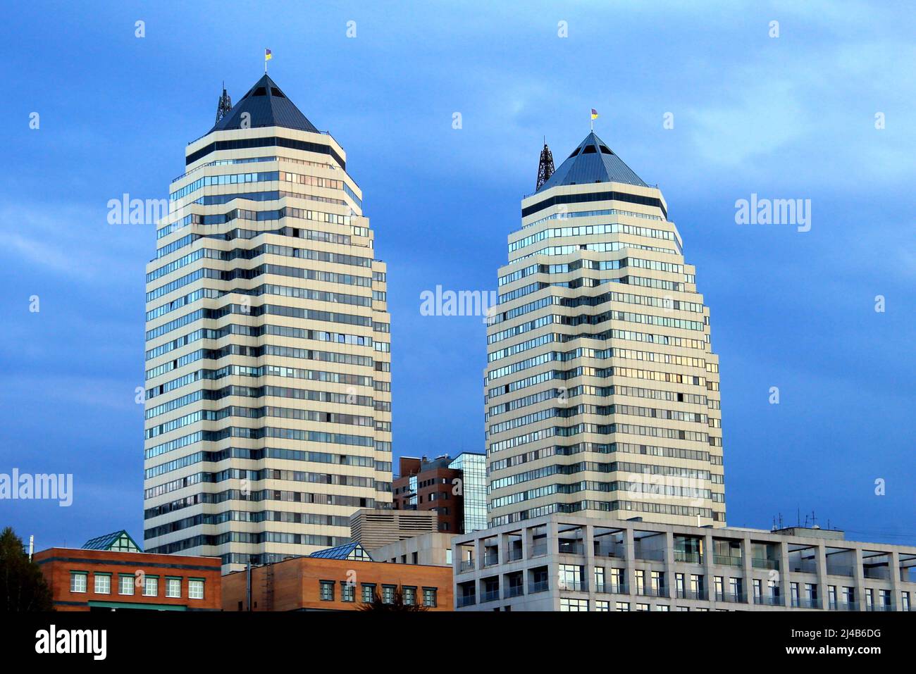 Tall white buildings, towers, skyscrapers against background of clouds ...