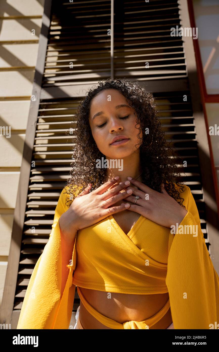 Portrait of a Colorful Young Black Woman Standing in front of Victorian ...