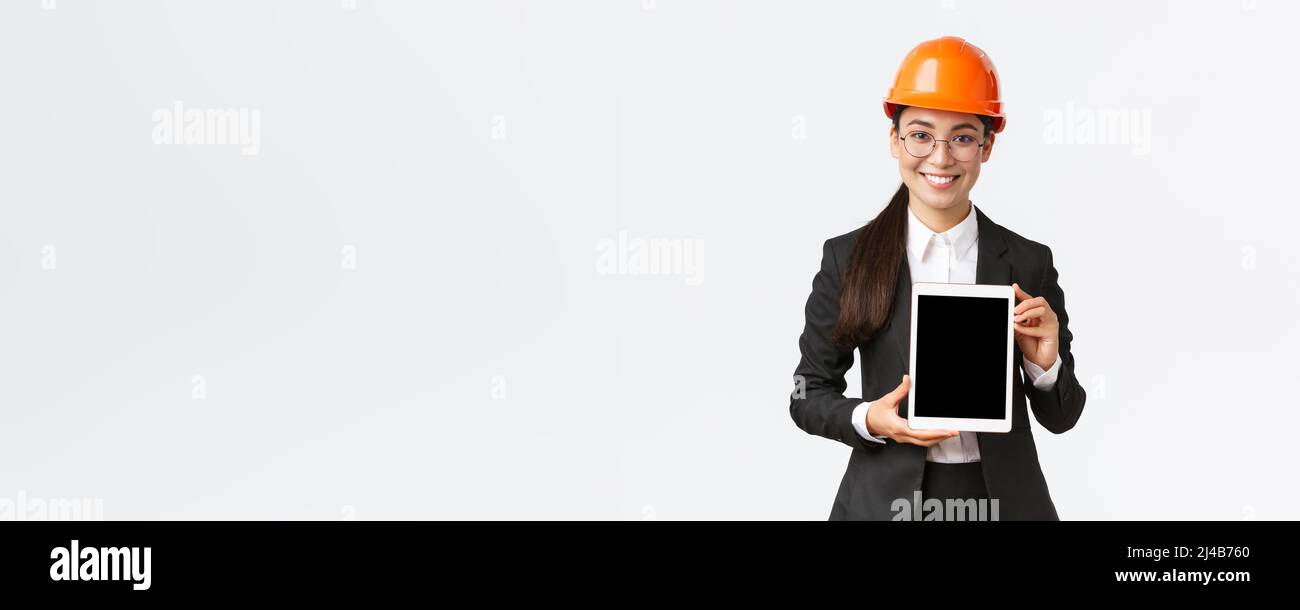 Smiling professional female engineer, saleswoman or estate agent ...