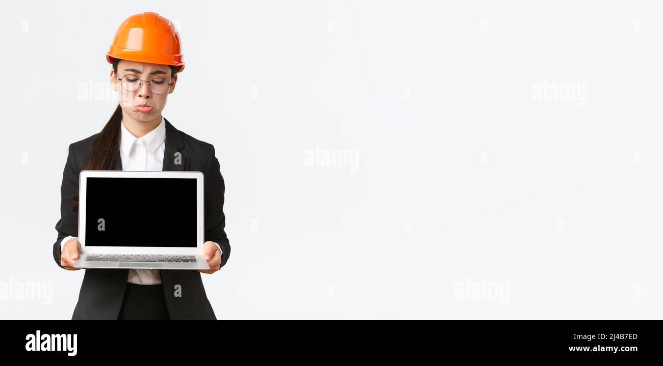 Disappointed gloomy asian female engineer showing bad results, wearing ...