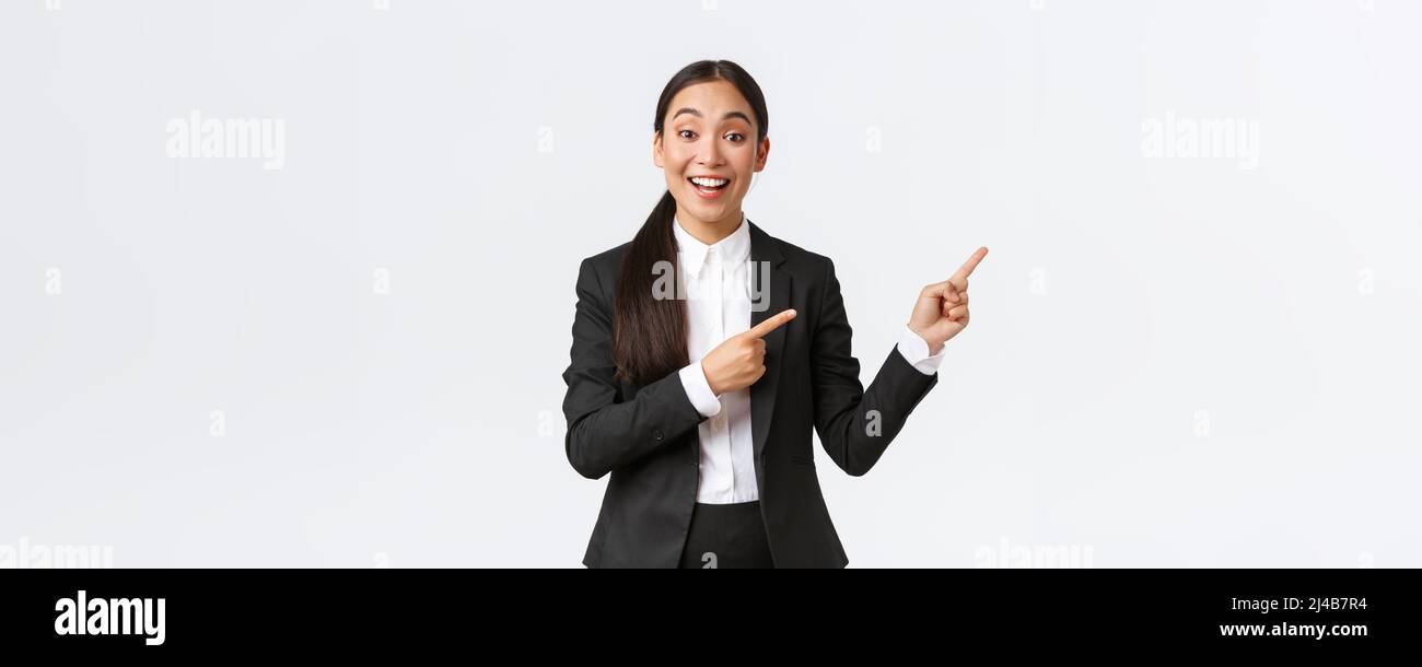 Excited female asian manager, saleswoman or real estate agent showing ...