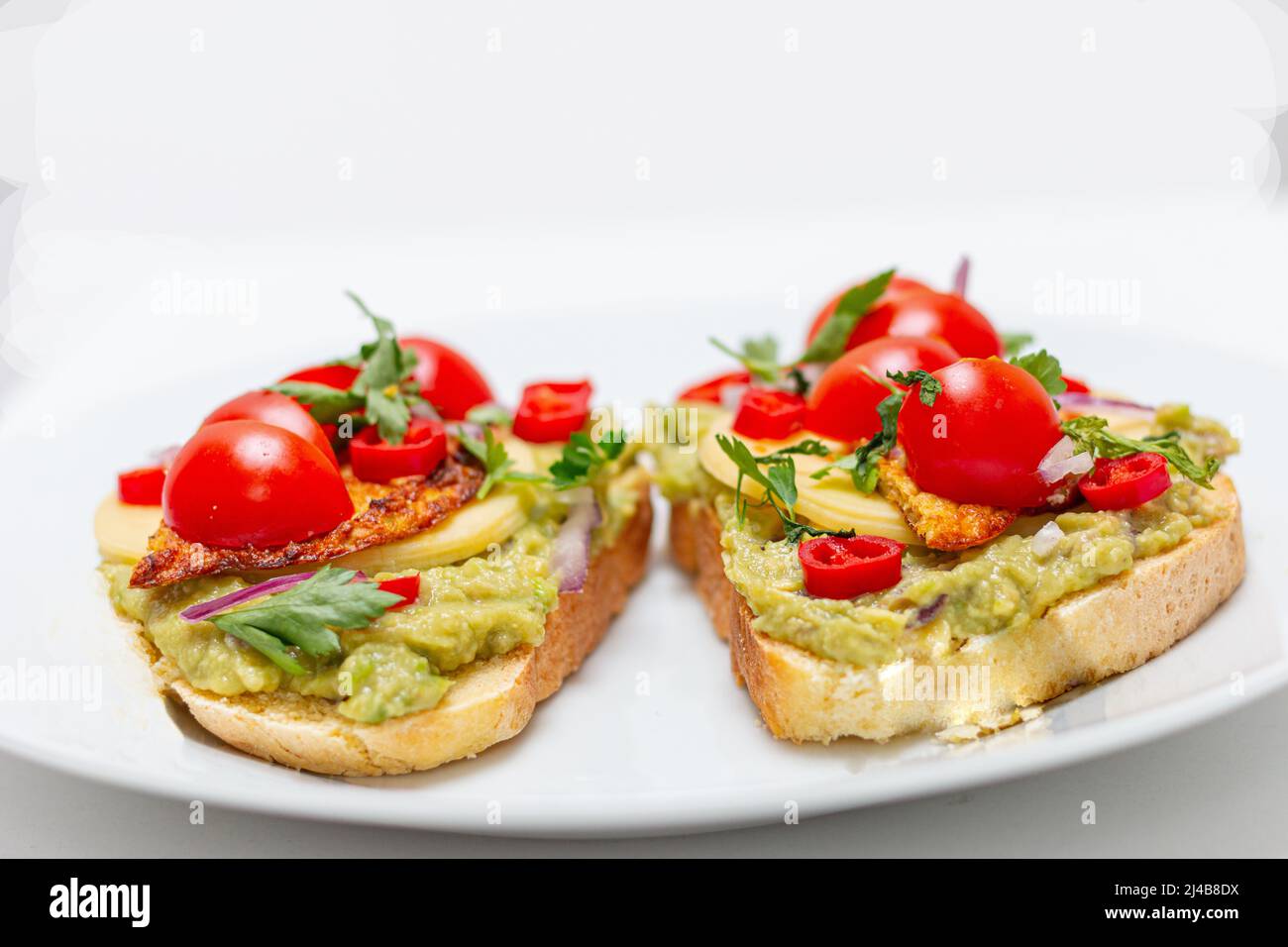 Healthy open vegan sandwich with avocado mash, zucchini, cherry ...