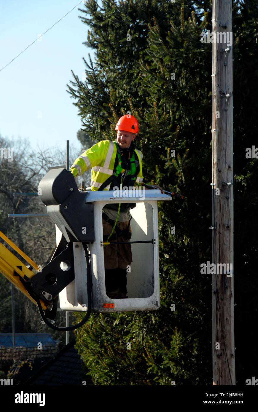 Engineer on hydraulic hoist working by a utility pole to improve ...