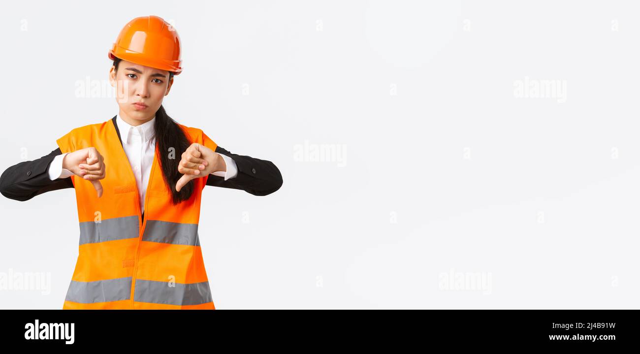 Disappointed and upset asian female chief engineer inspect bad work ...