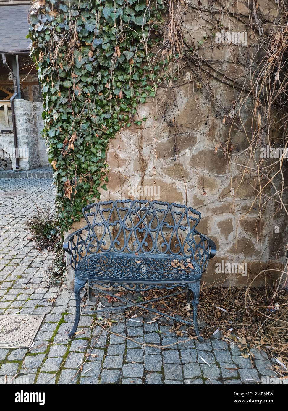 a beautiful bench near the stone wall in the garden Stock Photo - Alamy