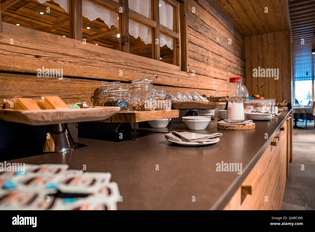 Nutritional food arranged on counter against window at luxurious dining ...