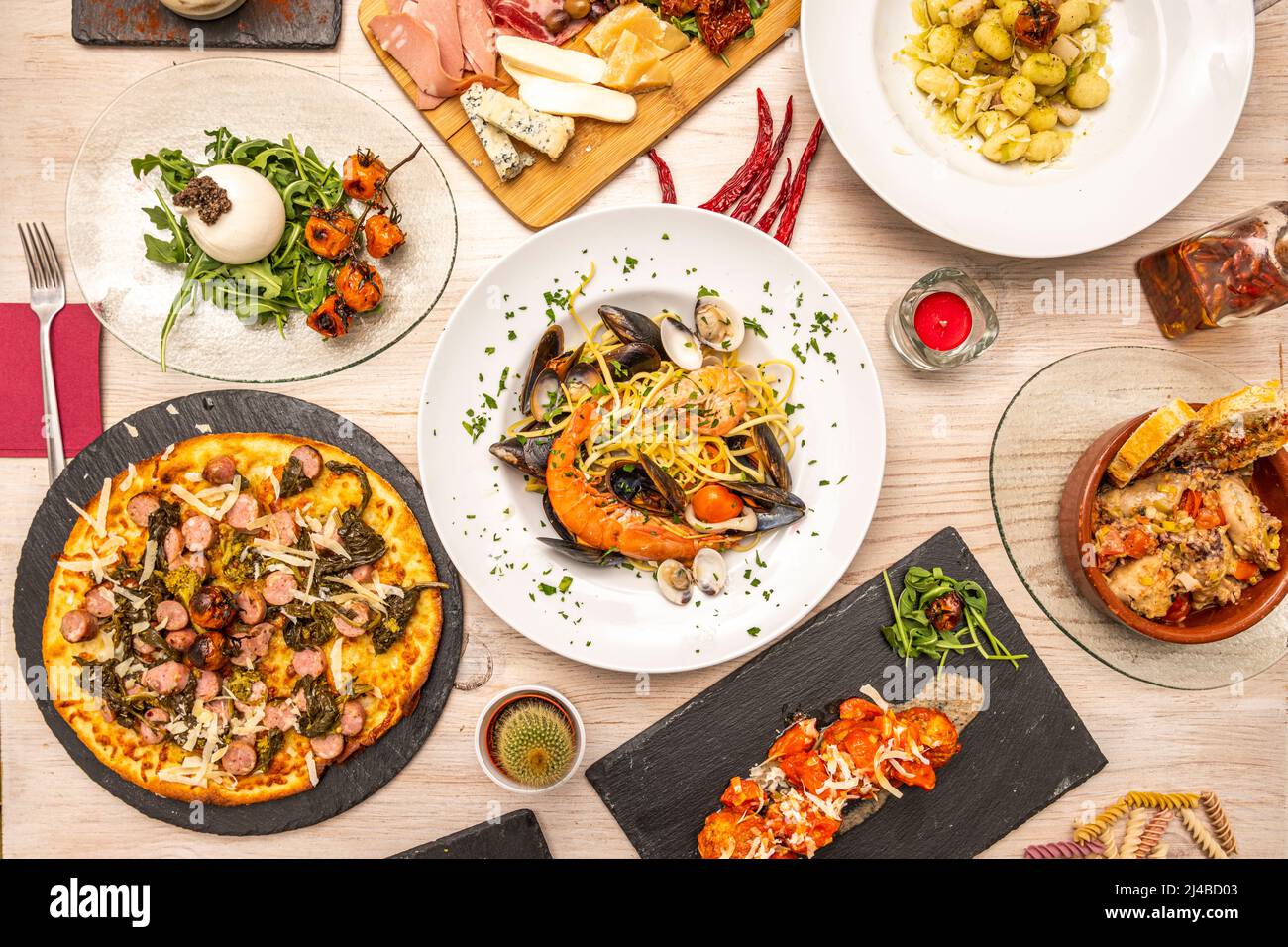 Top view of Italian food dishes, with pizza with sausages, pasta with ...