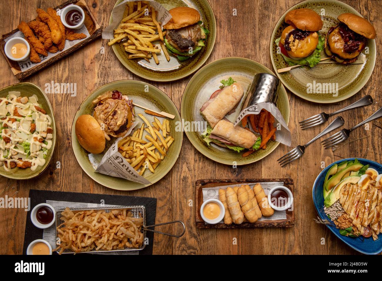 Set of fast food dishes with assorted hamburgers, sandwiches, sweet ...