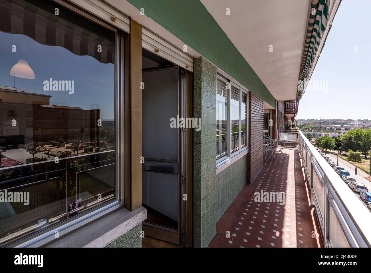 long veranda terrace with terrazzo floors and views of a park on a ...