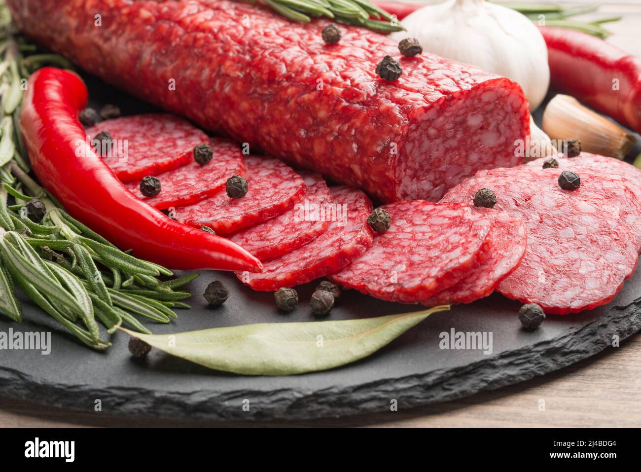 Sausage with salami with rosemary and vegetables Stock Photo - Alamy