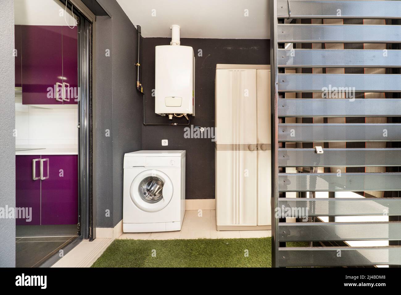 Drying terrace with natural gas boiler and washing machine next to an ...