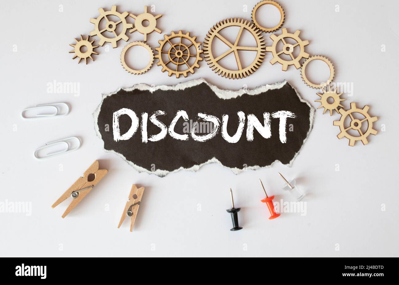 Discount- a paper price tag with a twine against red background ...