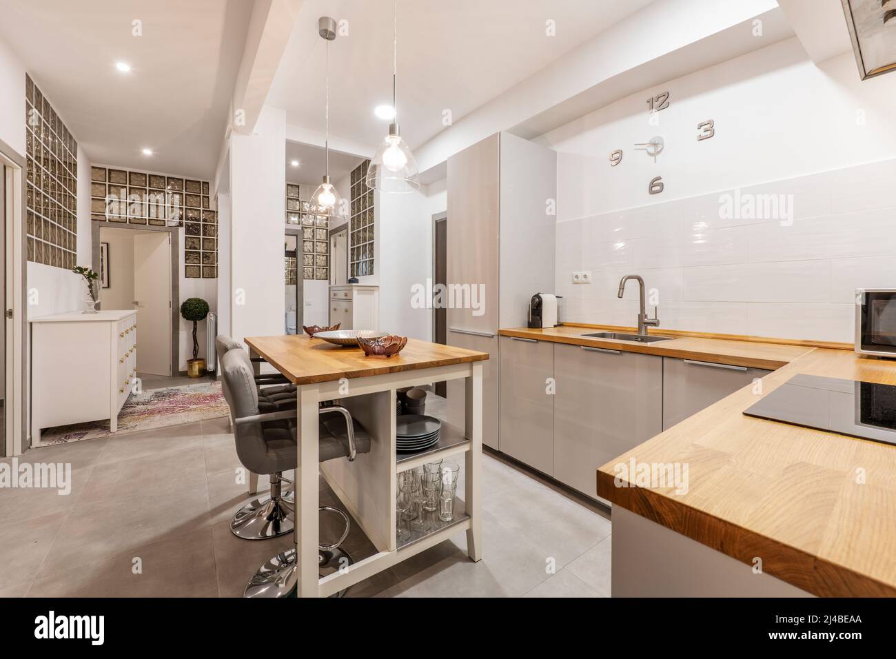Kitchen with gray cabinets and solid pine countertops, glass paved ...