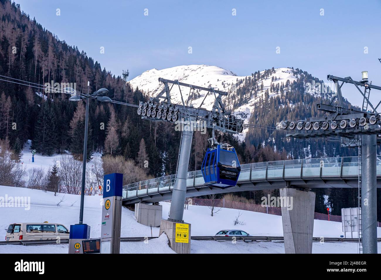 Cable car at station against snow covered mountains in alpine region ...