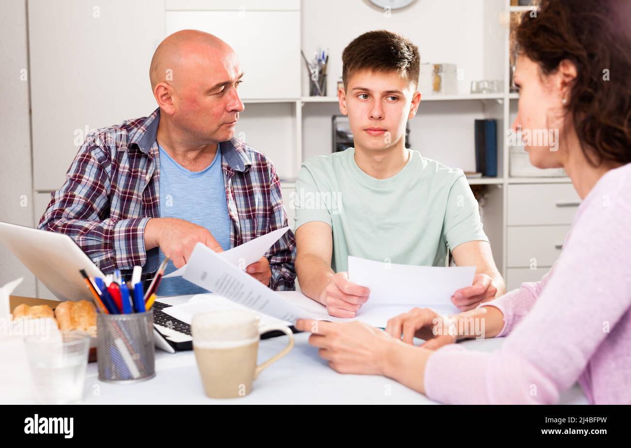 Family with son working with papers Stock Photo - Alamy