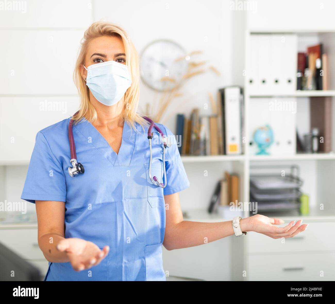 Therapist woman in protective mask is meeting next client Stock Photo ...