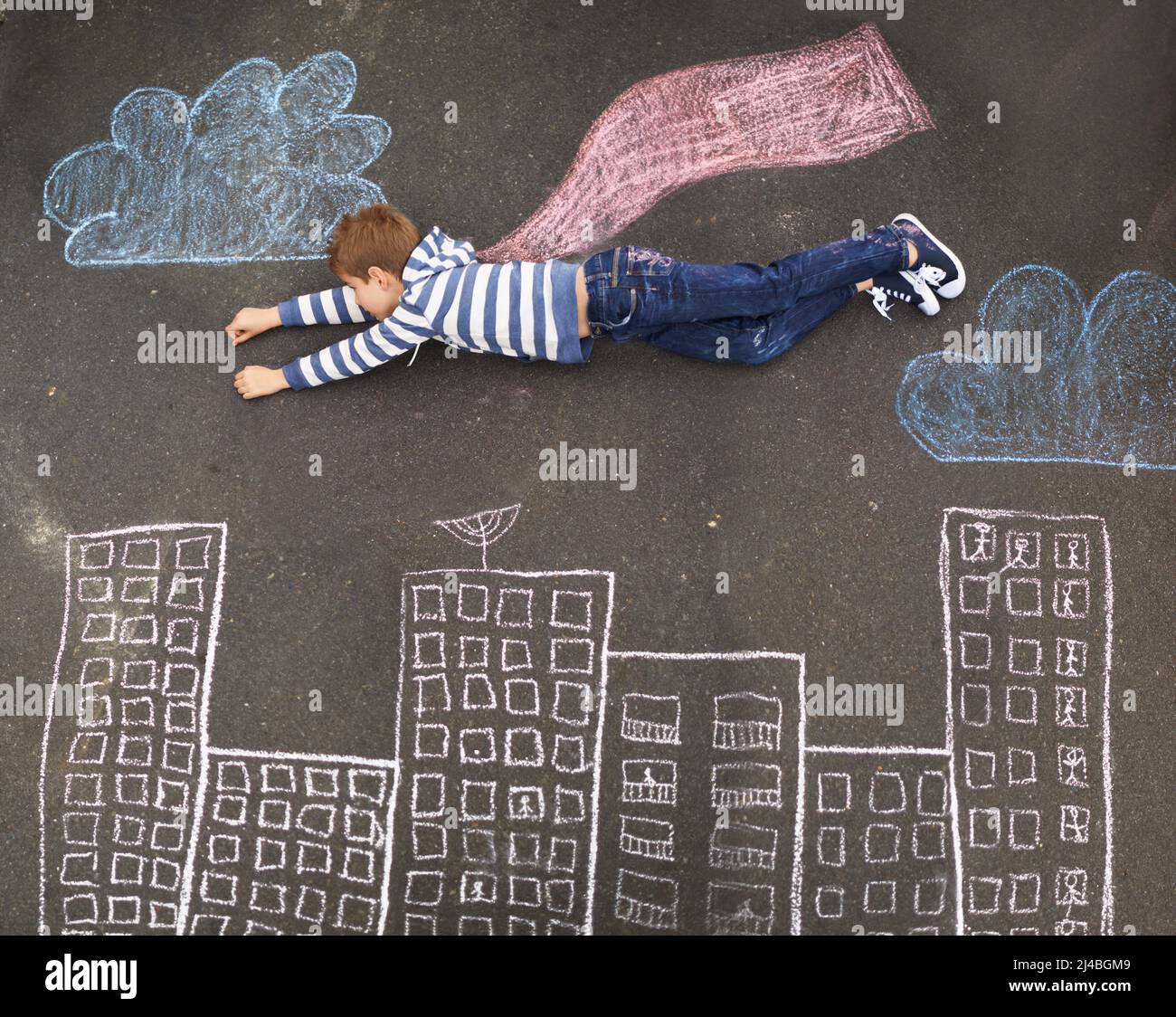 Whatever you can imagine.... Top view of a young boy using chalk and ...