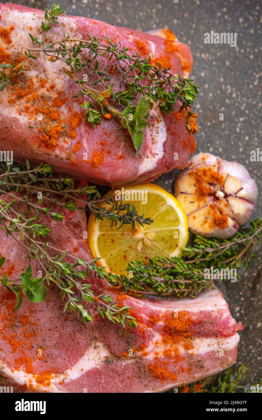 Pork with herbs and spices. Raw meat chunks, oregano, thyme, red pepper ...