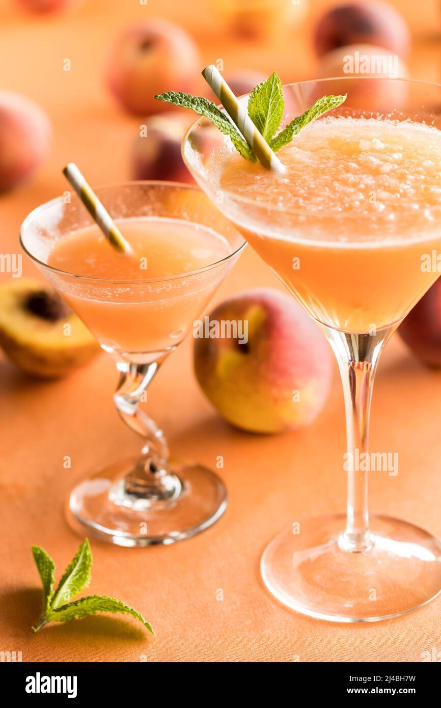 Two icy peach Bellini cocktails ready for drinking Stock Photo - Alamy