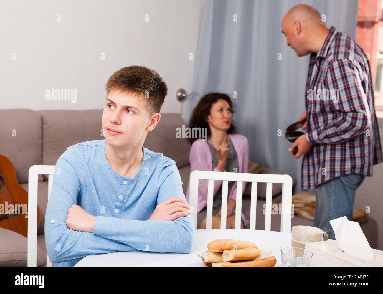 Son suffering from parents conflicts Stock Photo - Alamy
