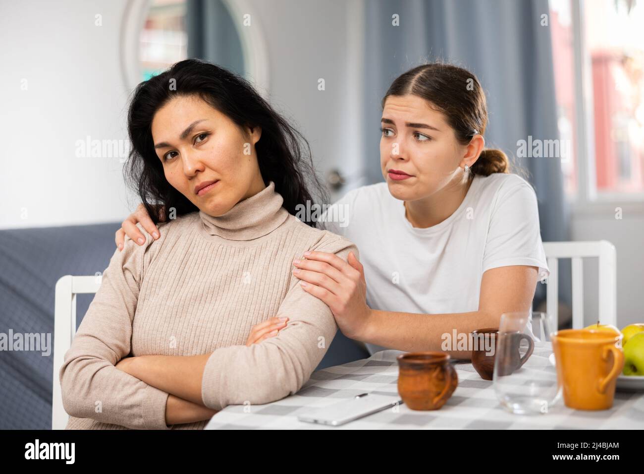 Young woman comforting her depressed female friend Stock Photo - Alamy