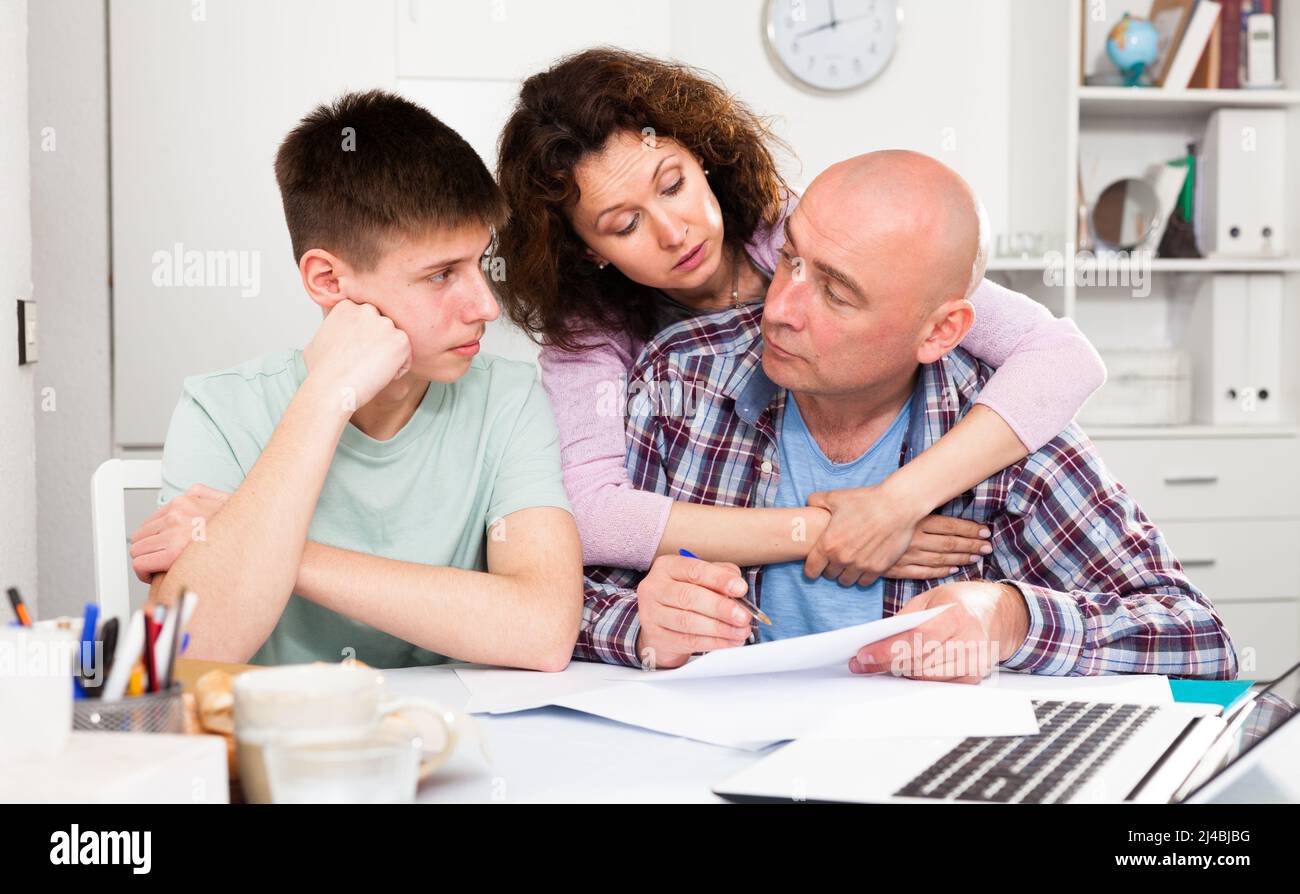 Family calculating domestic budget Stock Photo - Alamy