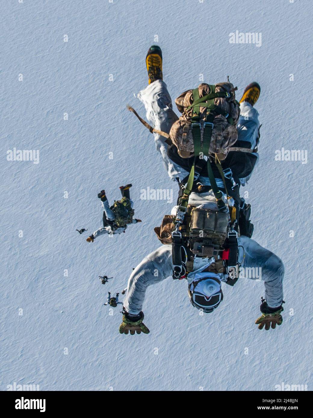 A Naval Special Warfare member performs a high-altitude low-opening ...