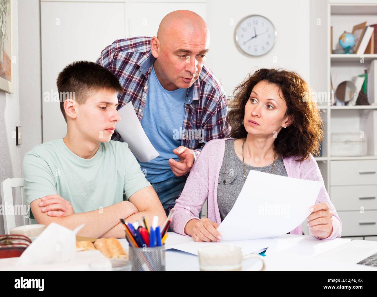 Family with son working with papers Stock Photo - Alamy