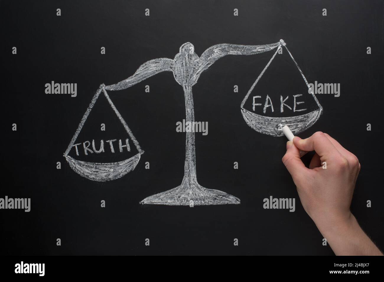 Scales with truth and fake. The concept on the blackboard Stock Photo ...