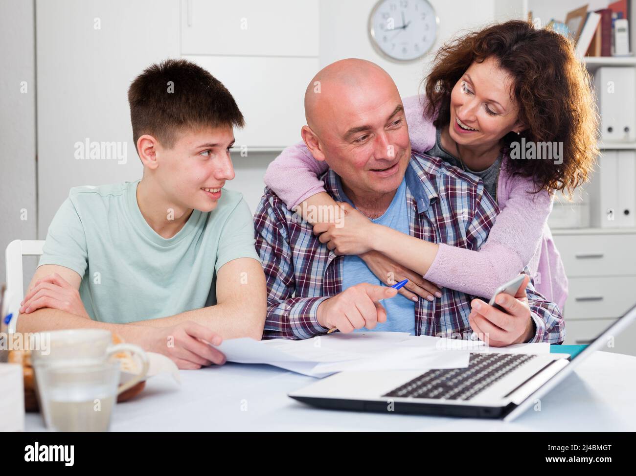 Family with son working with papers Stock Photo - Alamy
