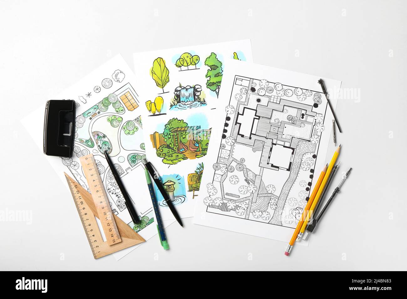 Paper sheets with sketches for landscape design and stationery on light ...