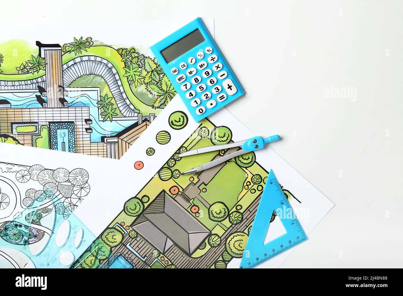 Landscape designer's plans with stationery and calculator on white ...