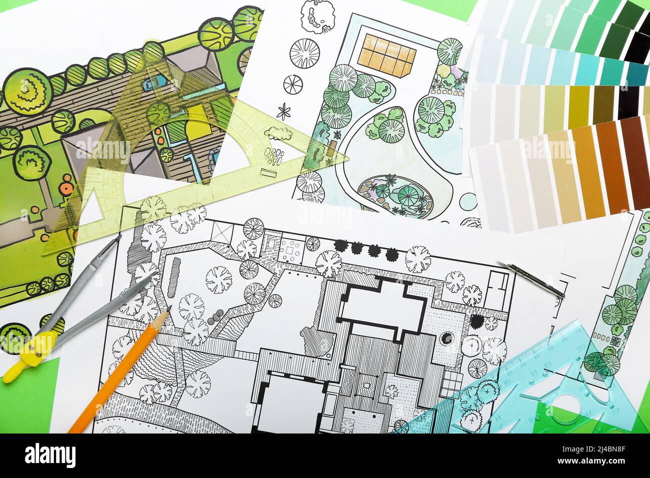 Landscape designer's plans with stationery and color samples on green ...