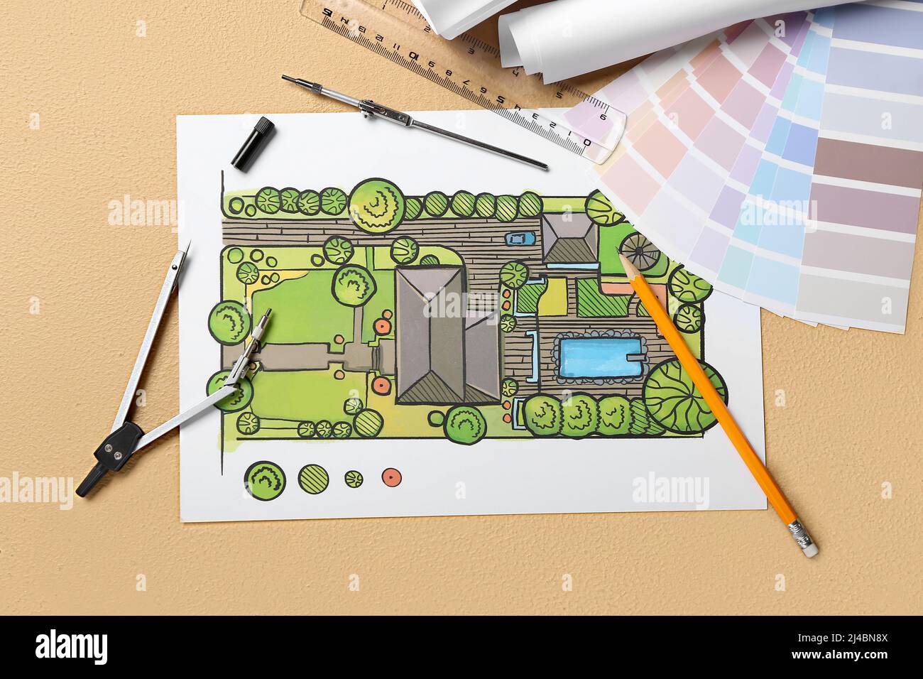 Landscape designer's plan with stationery and color samples on beige ...