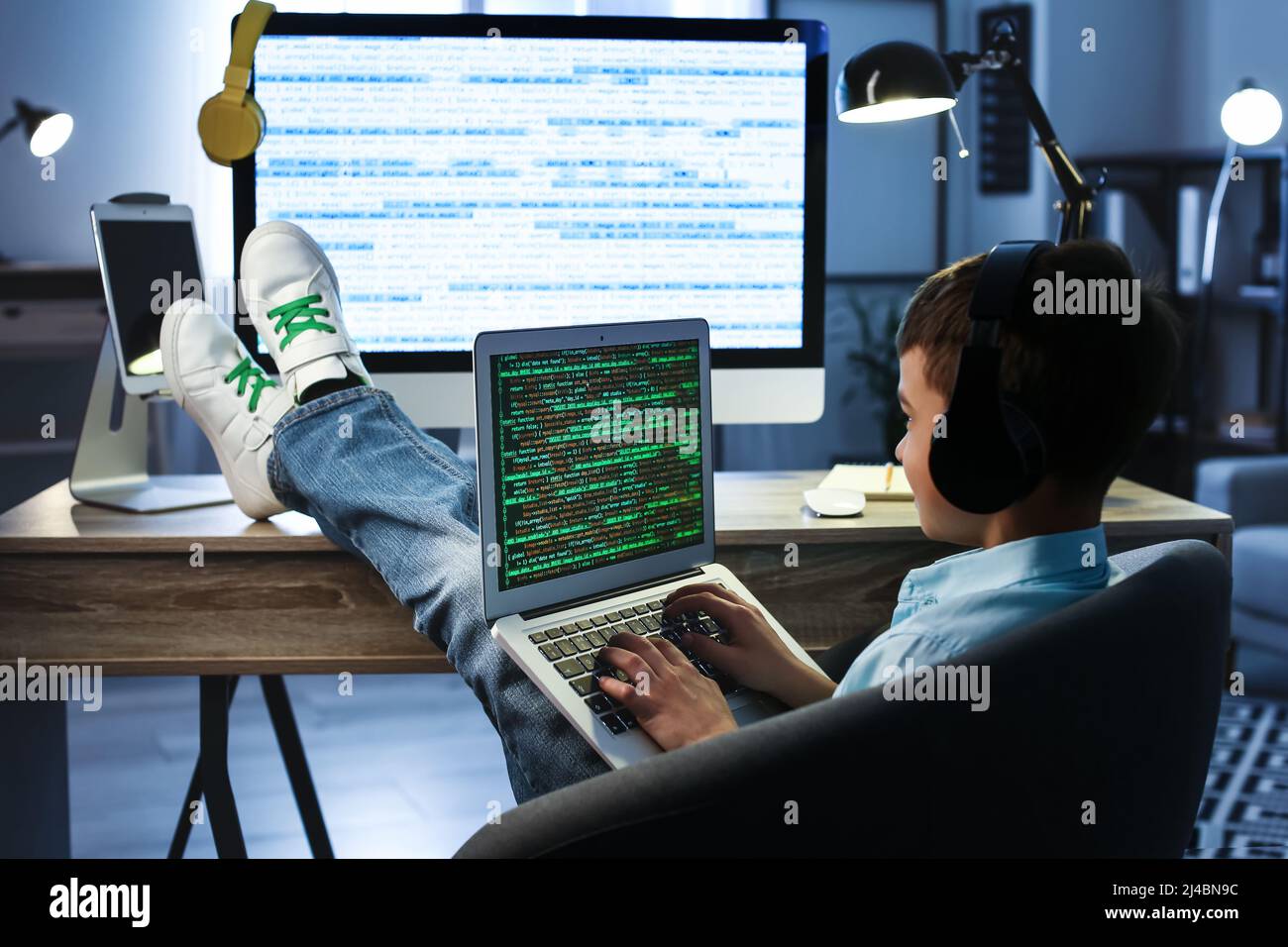 Cute little programmer using modern laptop at home Stock Photo - Alamy