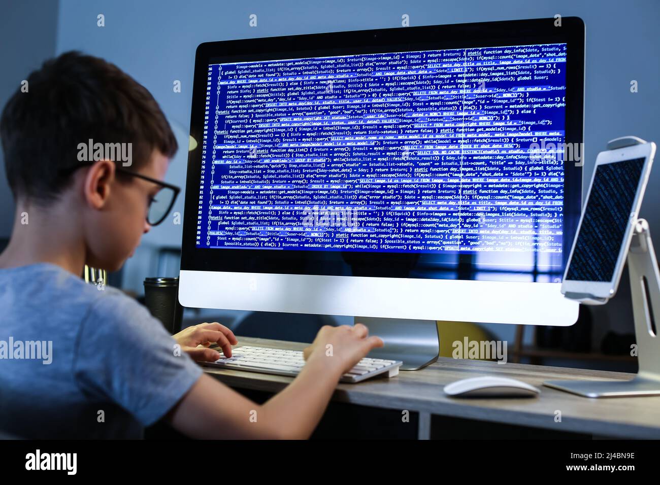 Cute little programmer using modern computer at home Stock Photo - Alamy