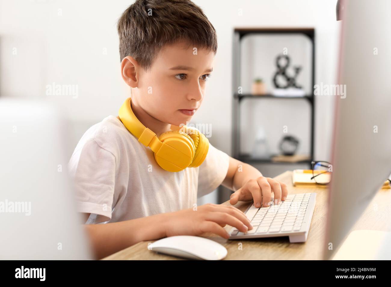 Cute little programmer using modern computer at home Stock Photo - Alamy