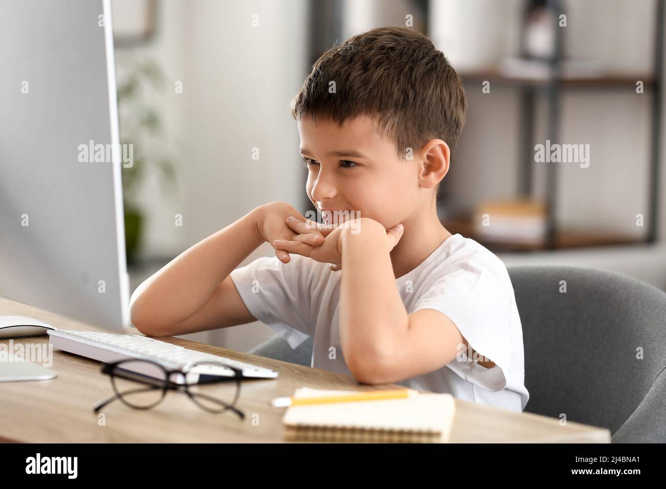 Cute little programmer using modern computer at home Stock Photo - Alamy