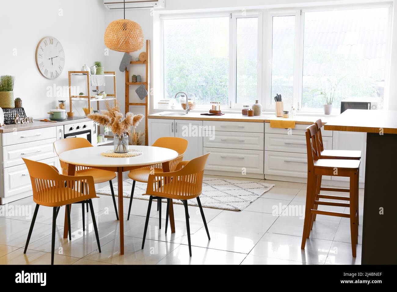 Dining table with chairs in modern interior of kitchen Stock Photo - Alamy