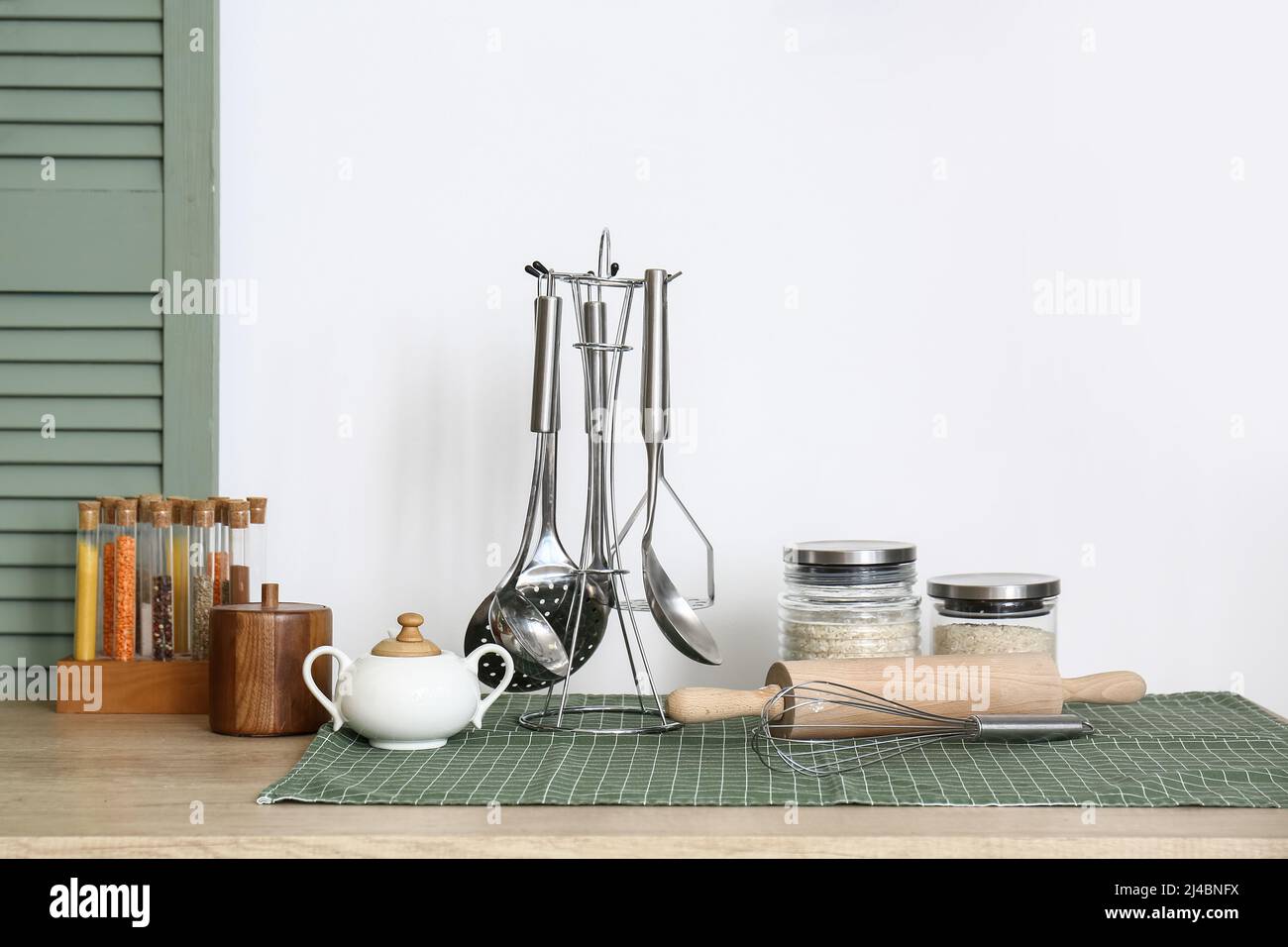 Wooden counter with utensils and products in modern kitchen Stock Photo ...
