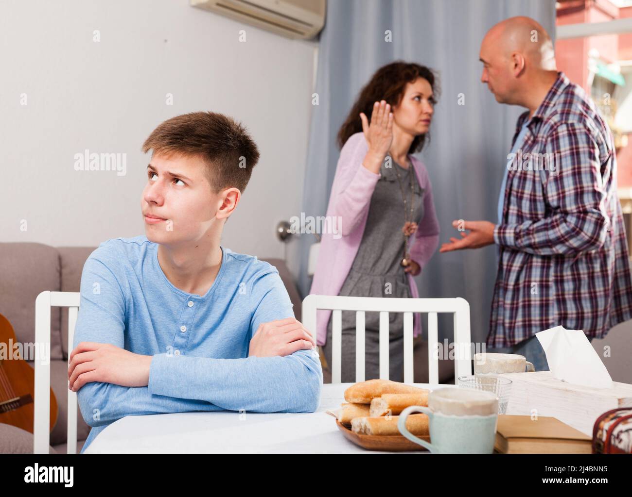 Son suffering from parents conflicts Stock Photo - Alamy