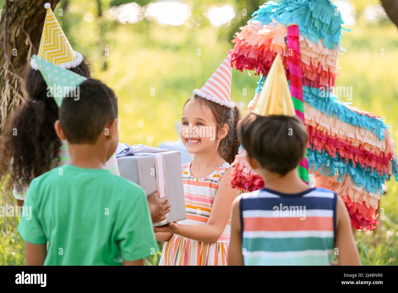 Cute children at pinata birthday party Stock Photo - Alamy