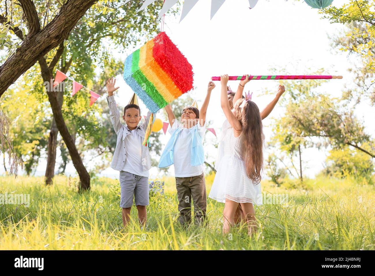 Cute children at pinata birthday party Stock Photo - Alamy