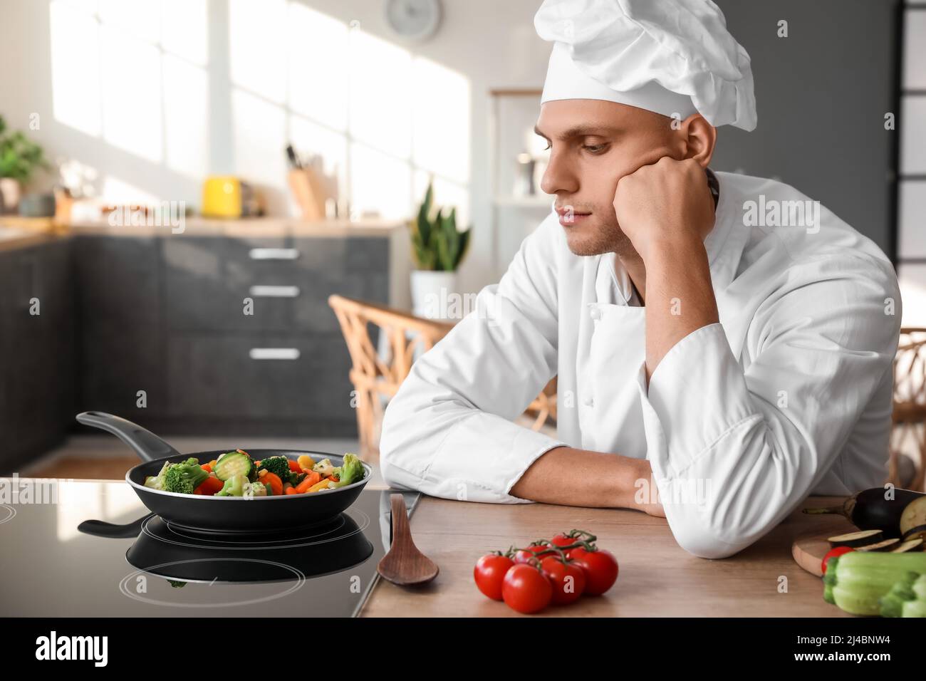Tired male chef frying tasty vegetables in kitchen Stock Photo - Alamy