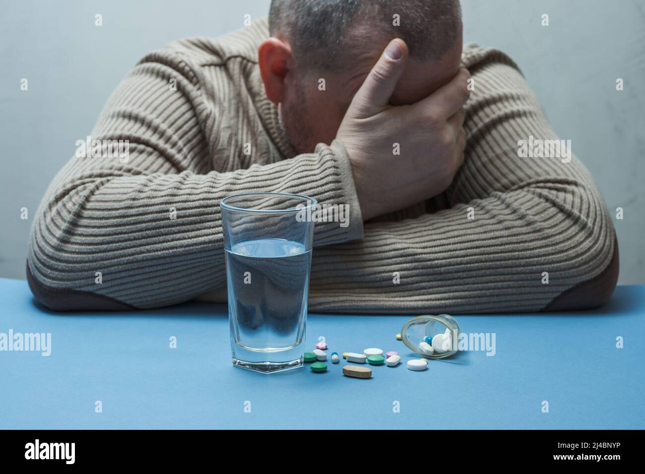 The man hides his face with his hands, the gesture symbolizes trouble ...