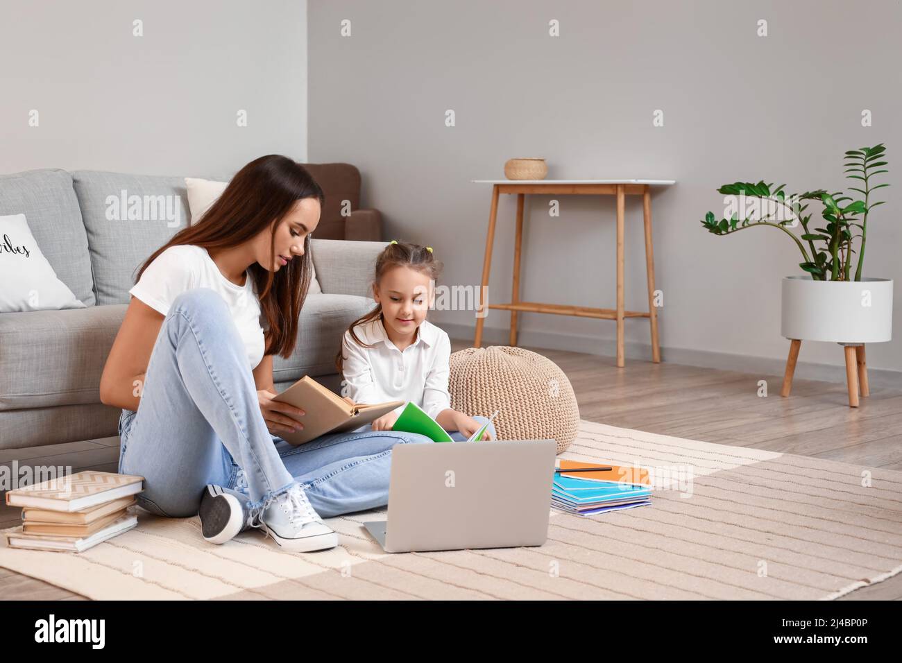 Cute girl studying with tutor at home Stock Photo - Alamy