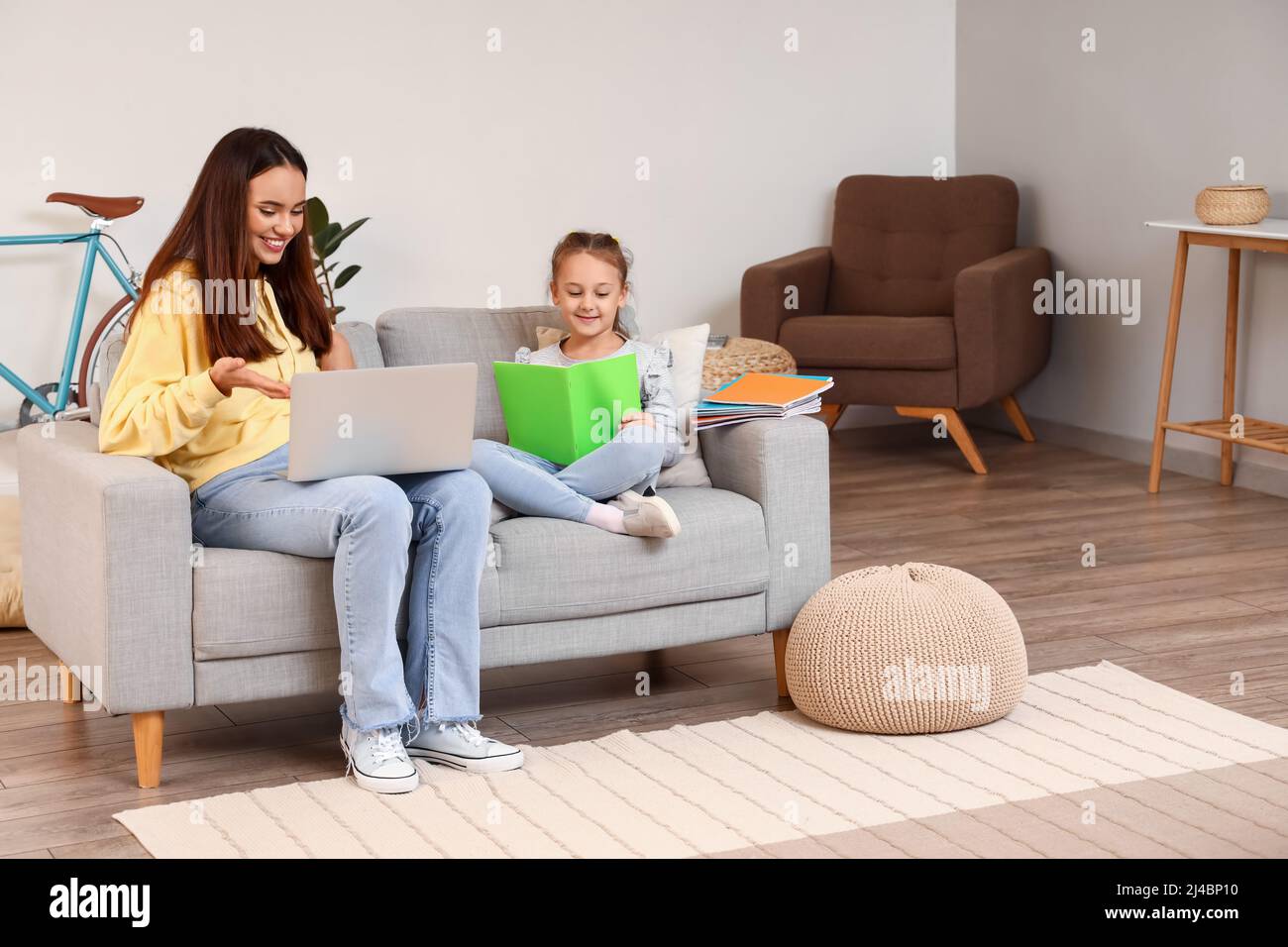 Cute girl studying with tutor at home Stock Photo - Alamy
